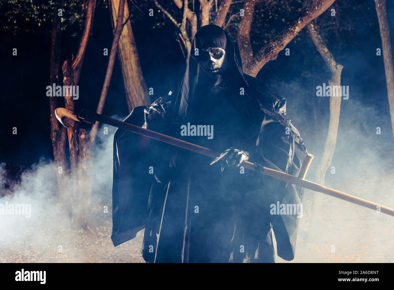 Grim Reaper standing in the fog at night with his scythe Stock Photo ...