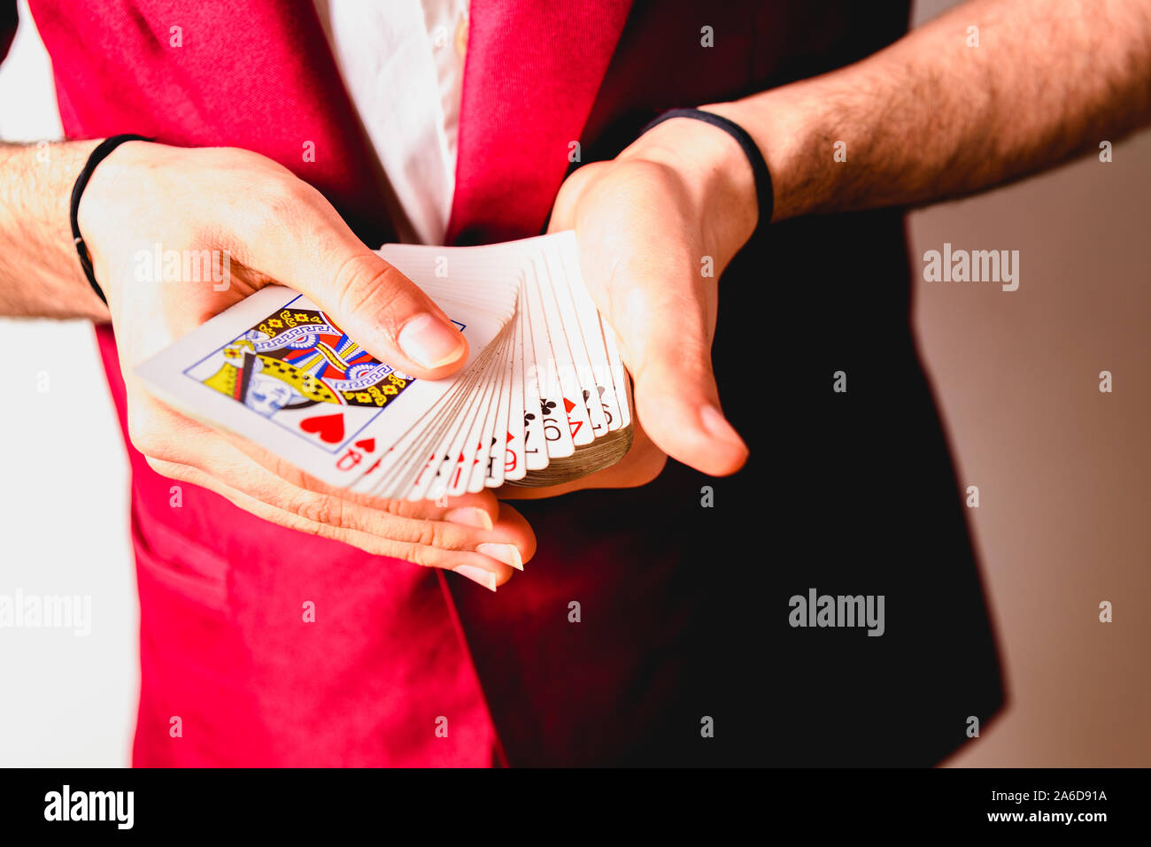 Hands of magician doing tricks with a deck of cards Stock Photo - Alamy