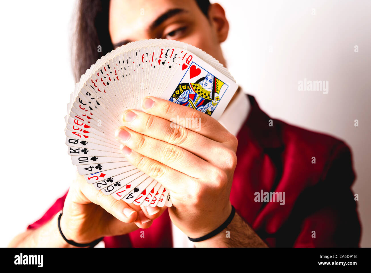 magician doing tricks with a deck of cards Stock Photo - Alamy