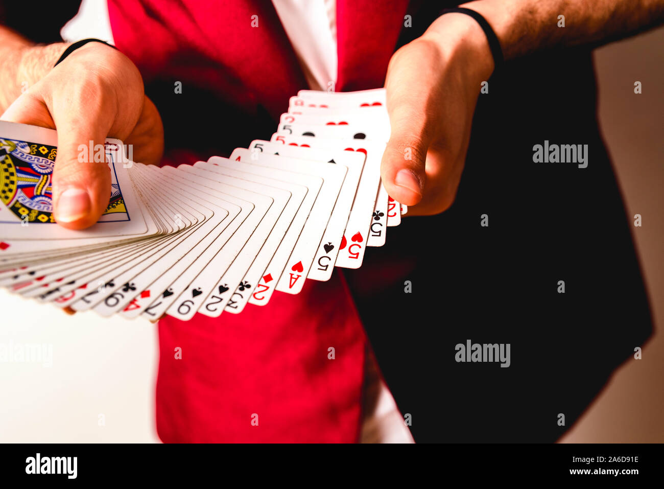 Hands of magician doing tricks with a deck of cards Stock Photo - Alamy