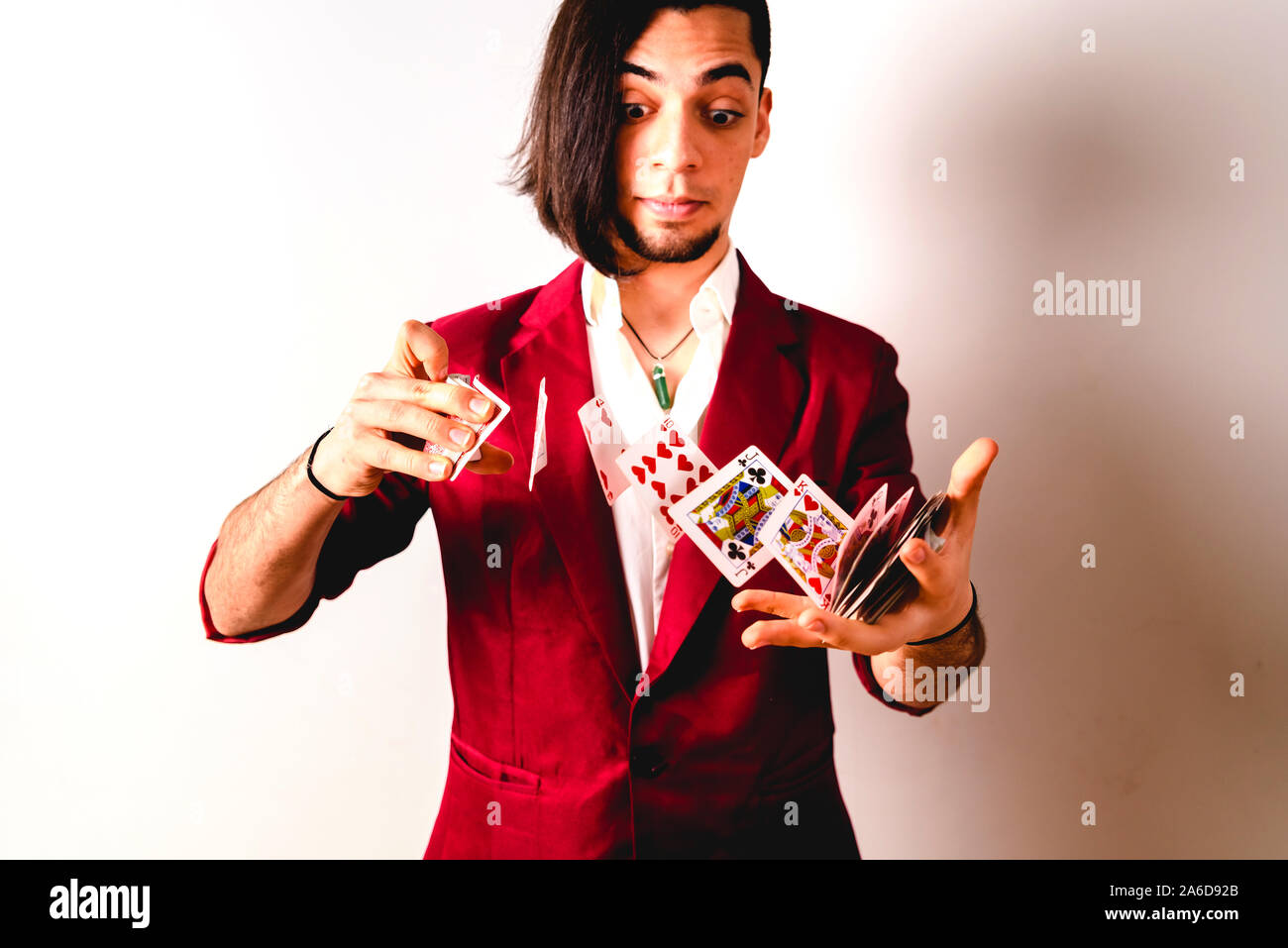 magician doing tricks with a deck of cards Stock Photo - Alamy