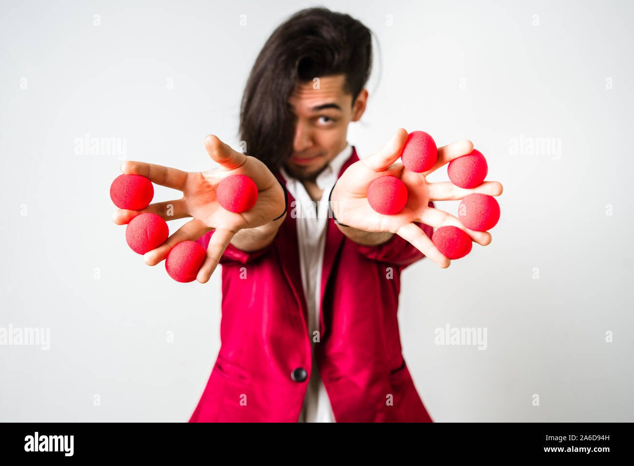 Juggler placing red balls between his fingers for fun and economic ...
