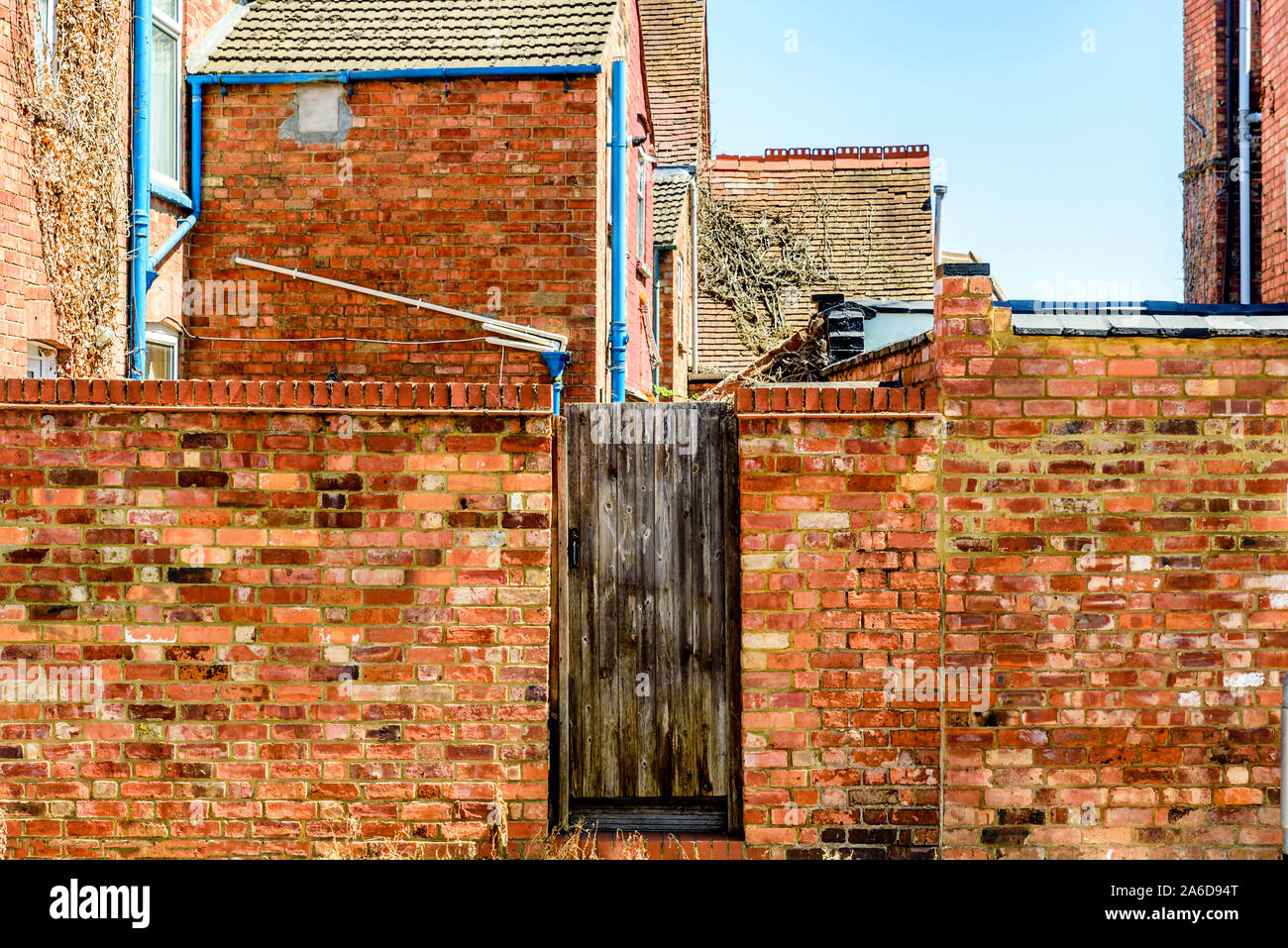 old wooden door gate in red brick wall in england town Stock Photo - Alamy