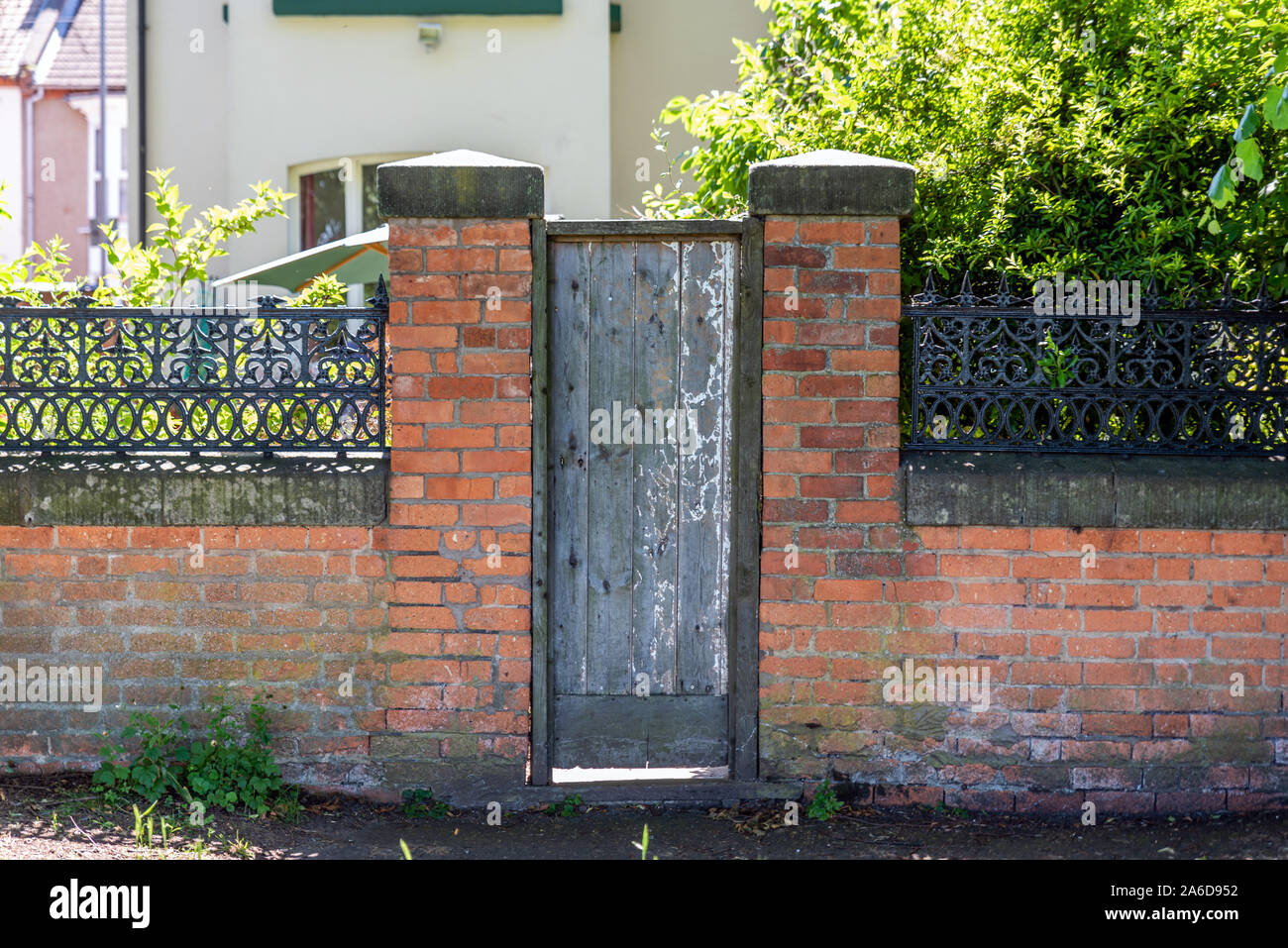 old wooden door gate in red brick wall in england town Stock Photo - Alamy