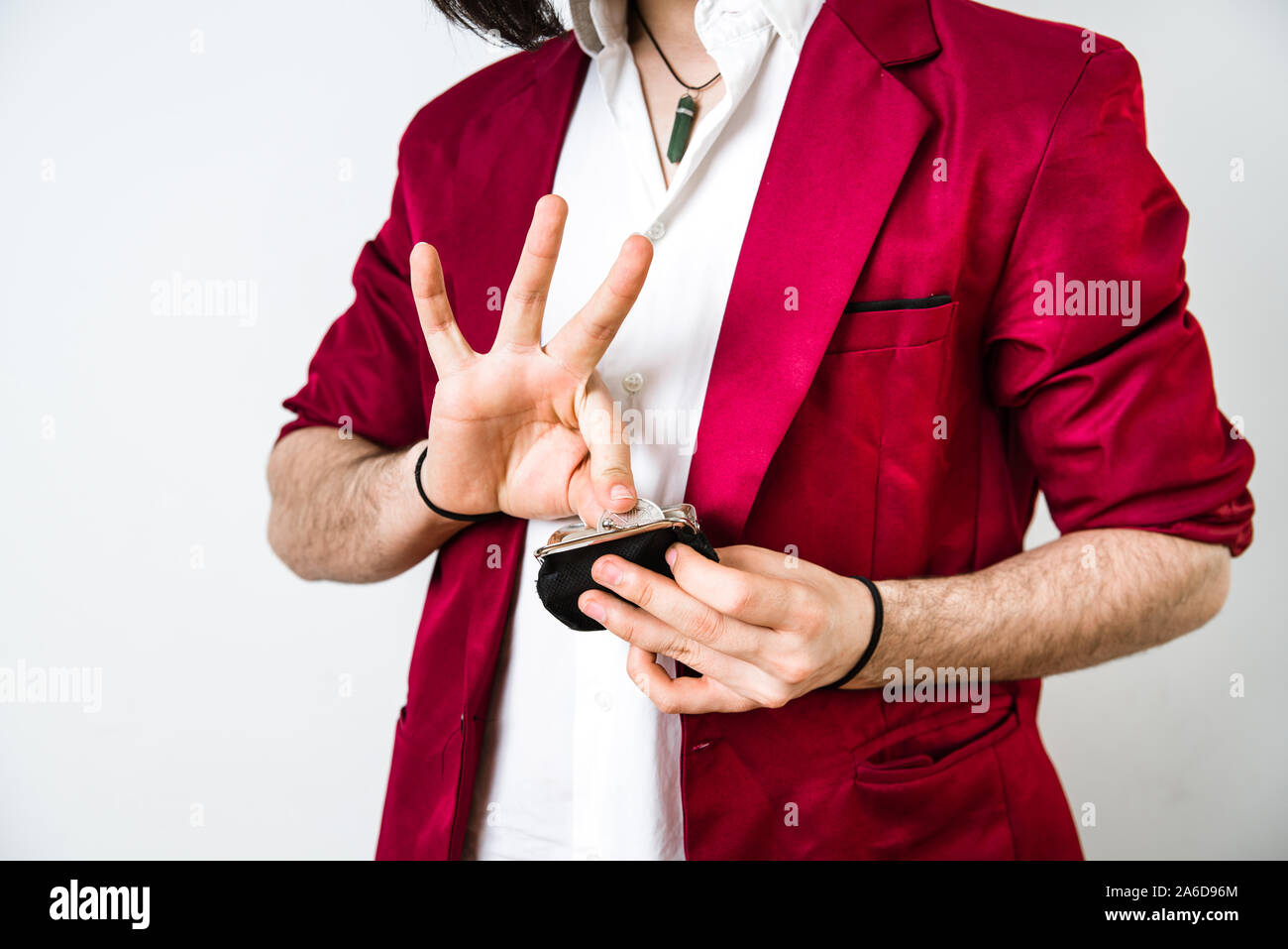 Young man manages some coins to make ends meet with his poor salary ...