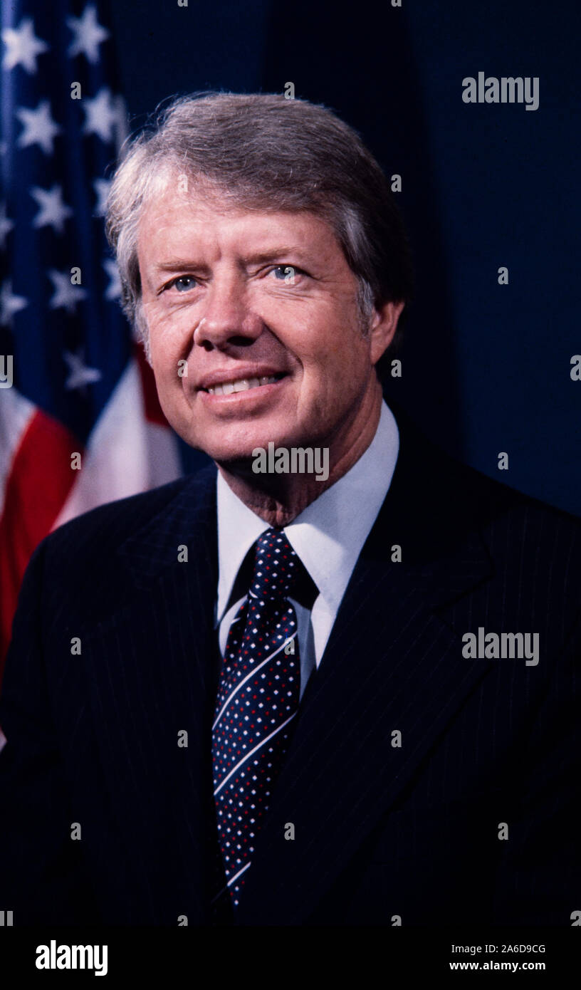 Portrait of President Jimmy Carter in dark suit with US flag in ...