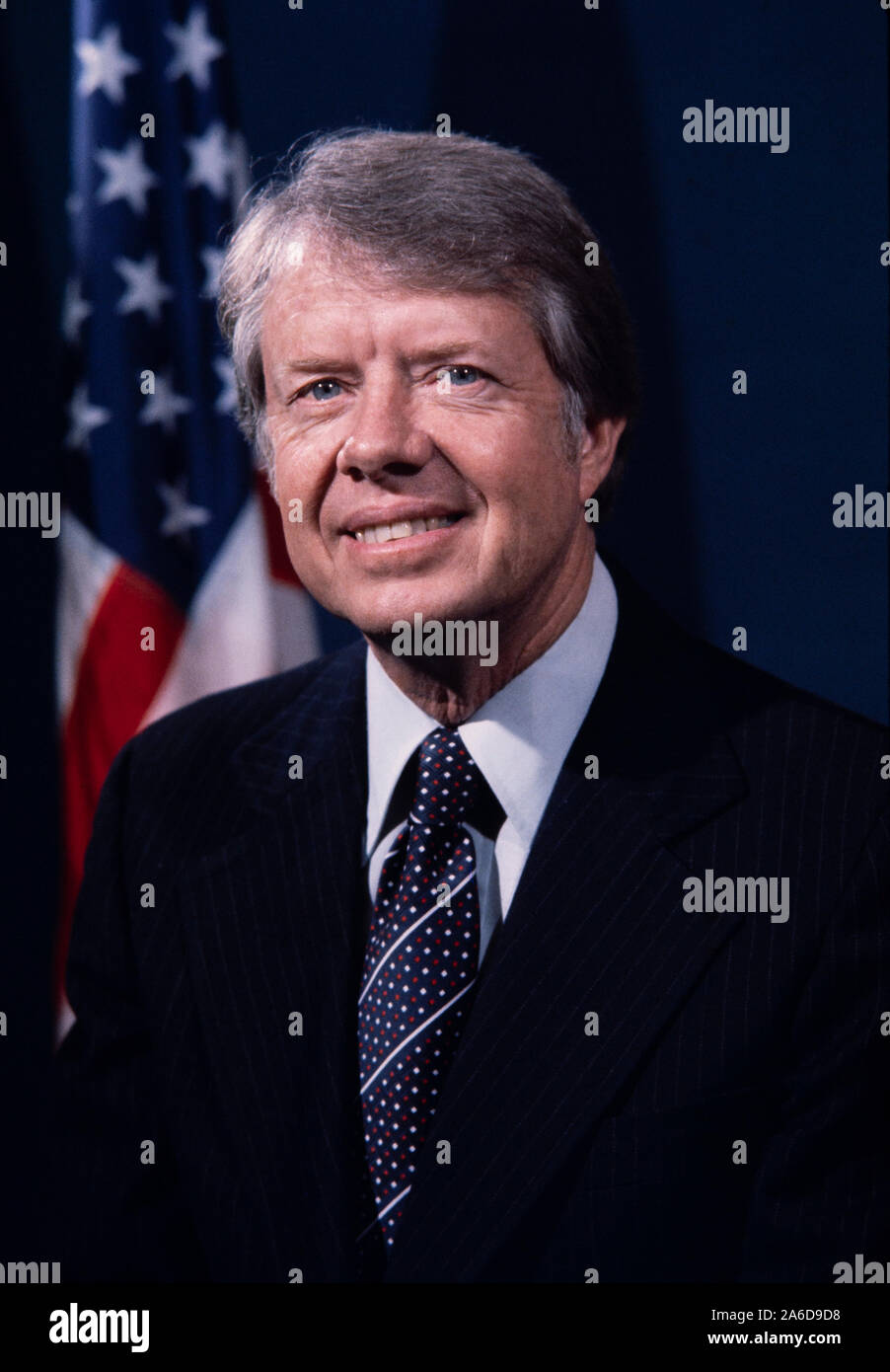 Portrait of President Jimmy Carter in dark suit with US flag in ...