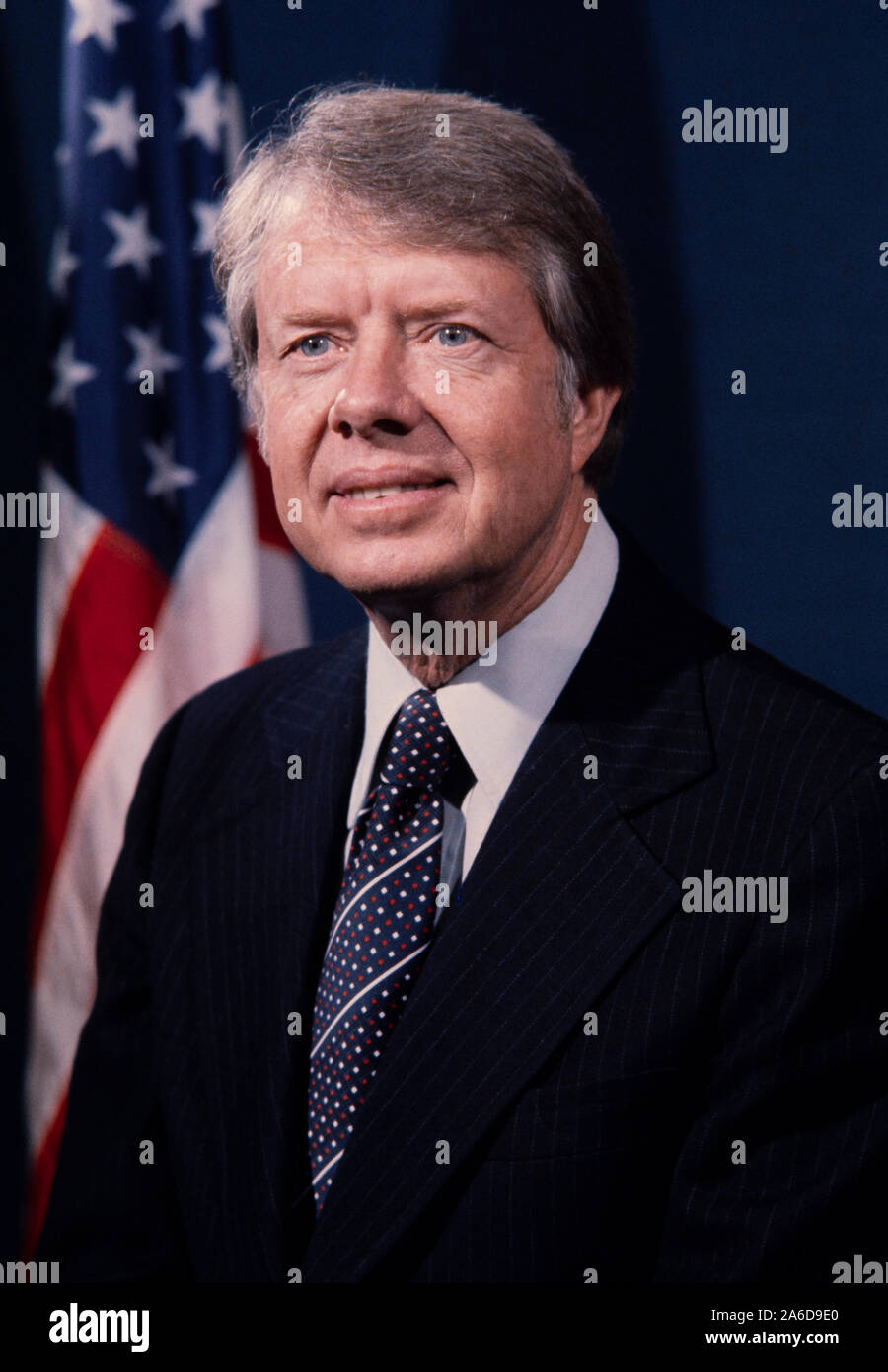 Portrait of President Jimmy Carter in dark suit with US flag in ...