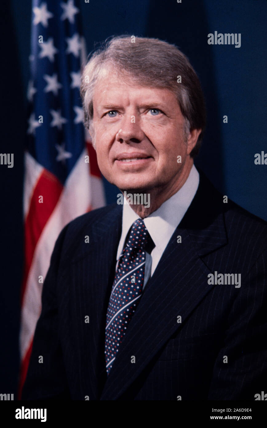 Portrait of President Jimmy Carter in dark suit with US flag in ...