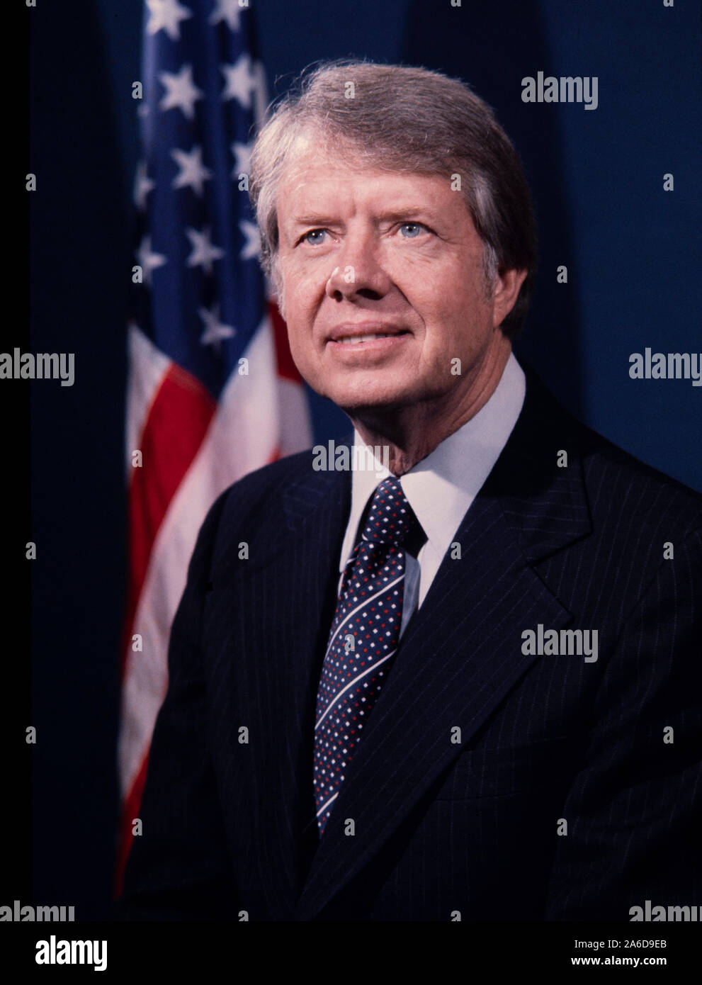 Portrait of President Jimmy Carter in dark suit with US flag in ...