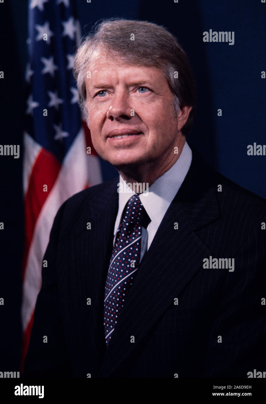 Portrait of President Jimmy Carter in dark suit with US flag in ...