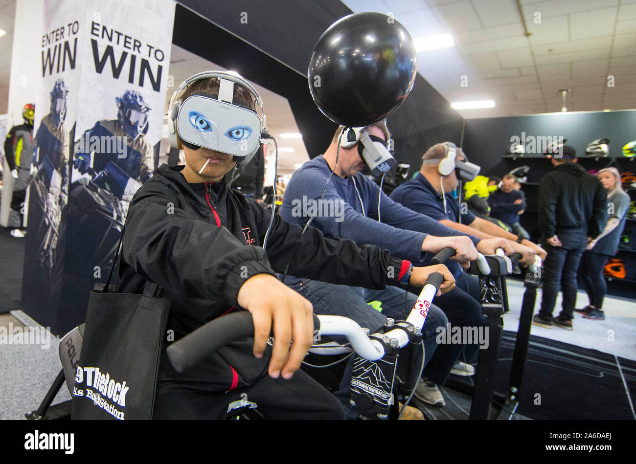 Toronto, Canada. 25th Oct, 2019. People try snowmobile VR games during ...
