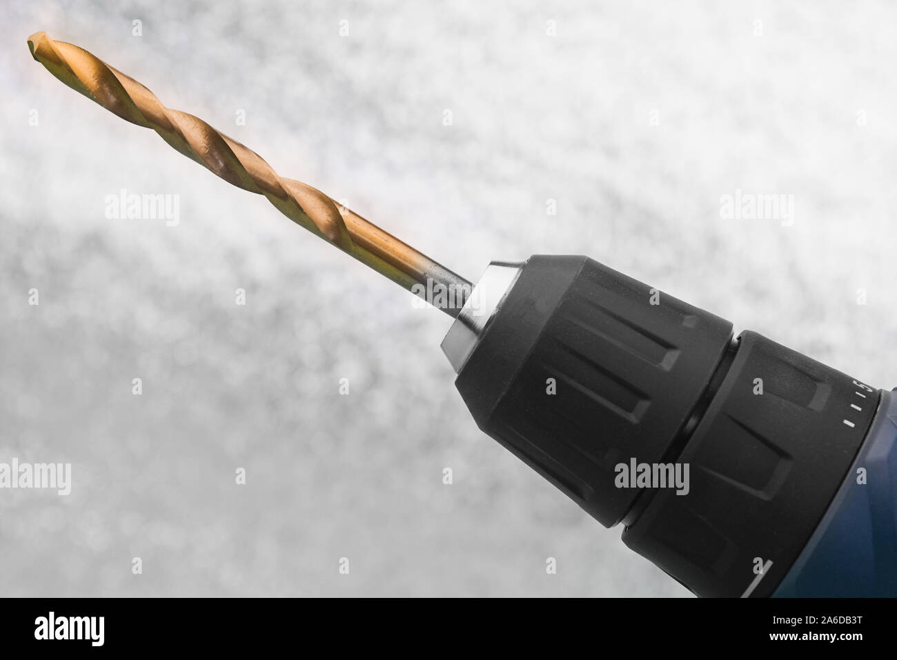 Yellow drill bit in the drill closeop on grey background. Suitable for ...