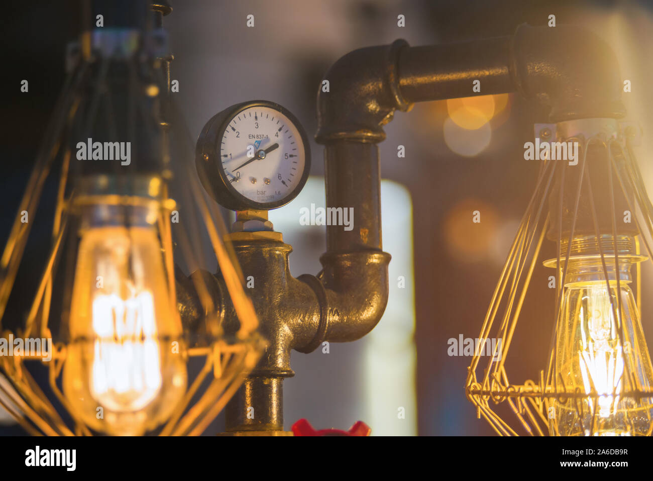 Old vintage pressure gauge with old rusty metal pipes closeup with lens ...