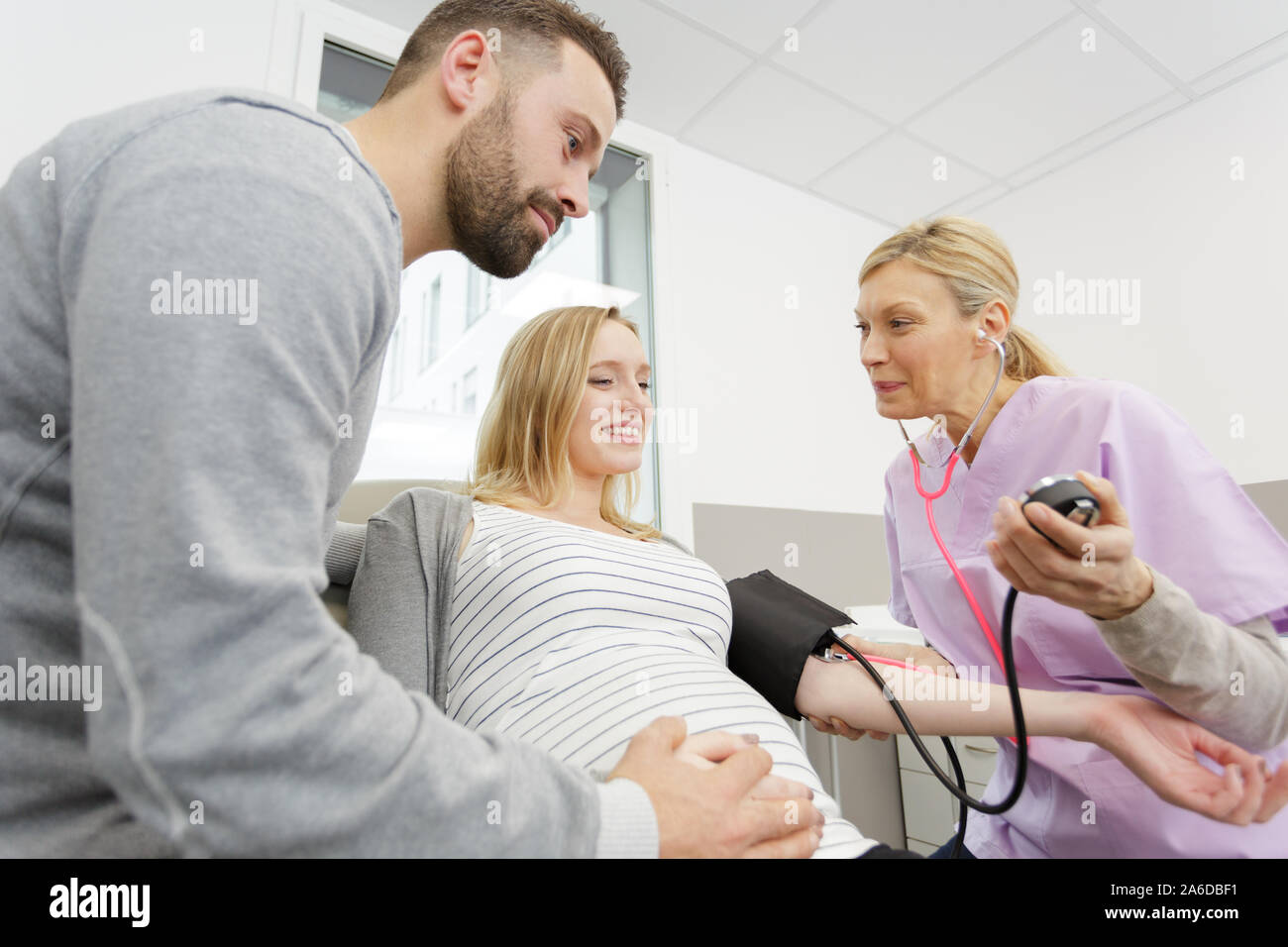 pregnant woman getting her pulse checked Stock Photo - Alamy
