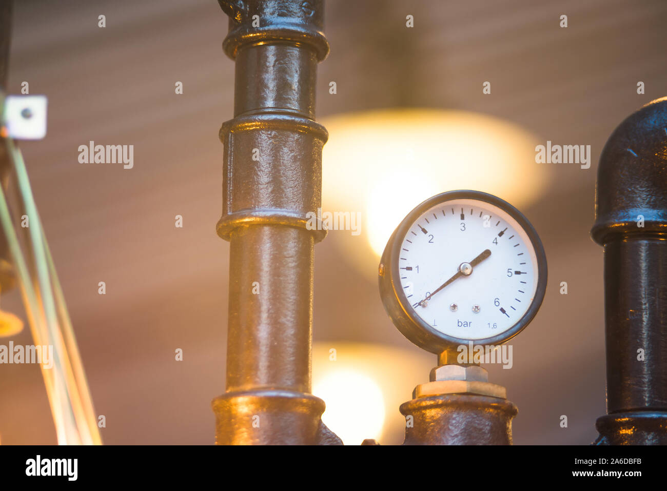 Old vintage pressure gauge with old rusty metal pipes closeup with lens ...