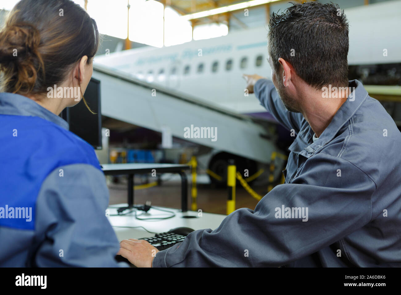 two modern aircraft engineers pointing an airplane Stock Photo - Alamy