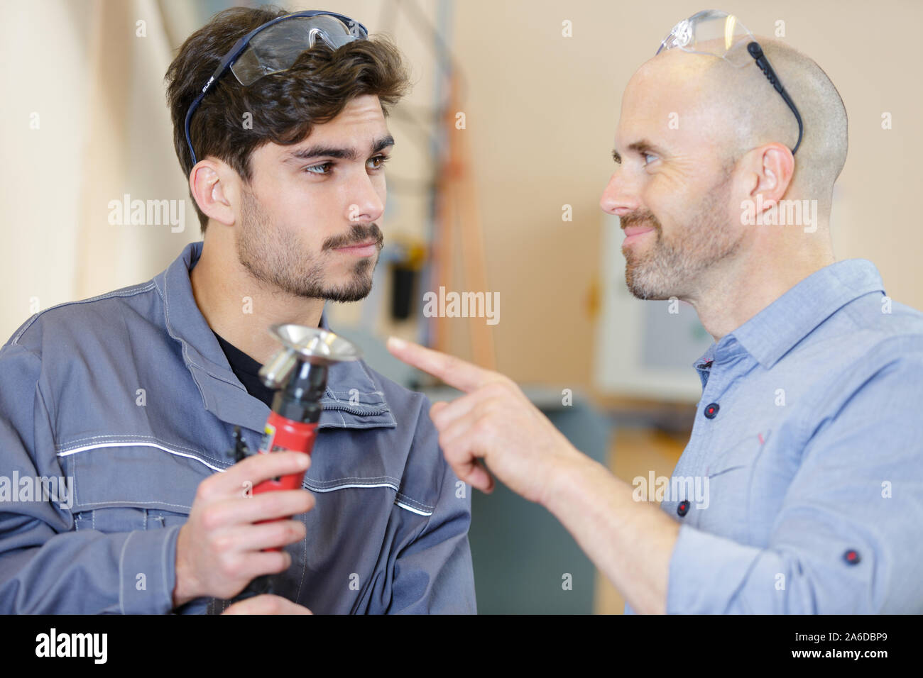 two men at work operating machine Stock Photo - Alamy