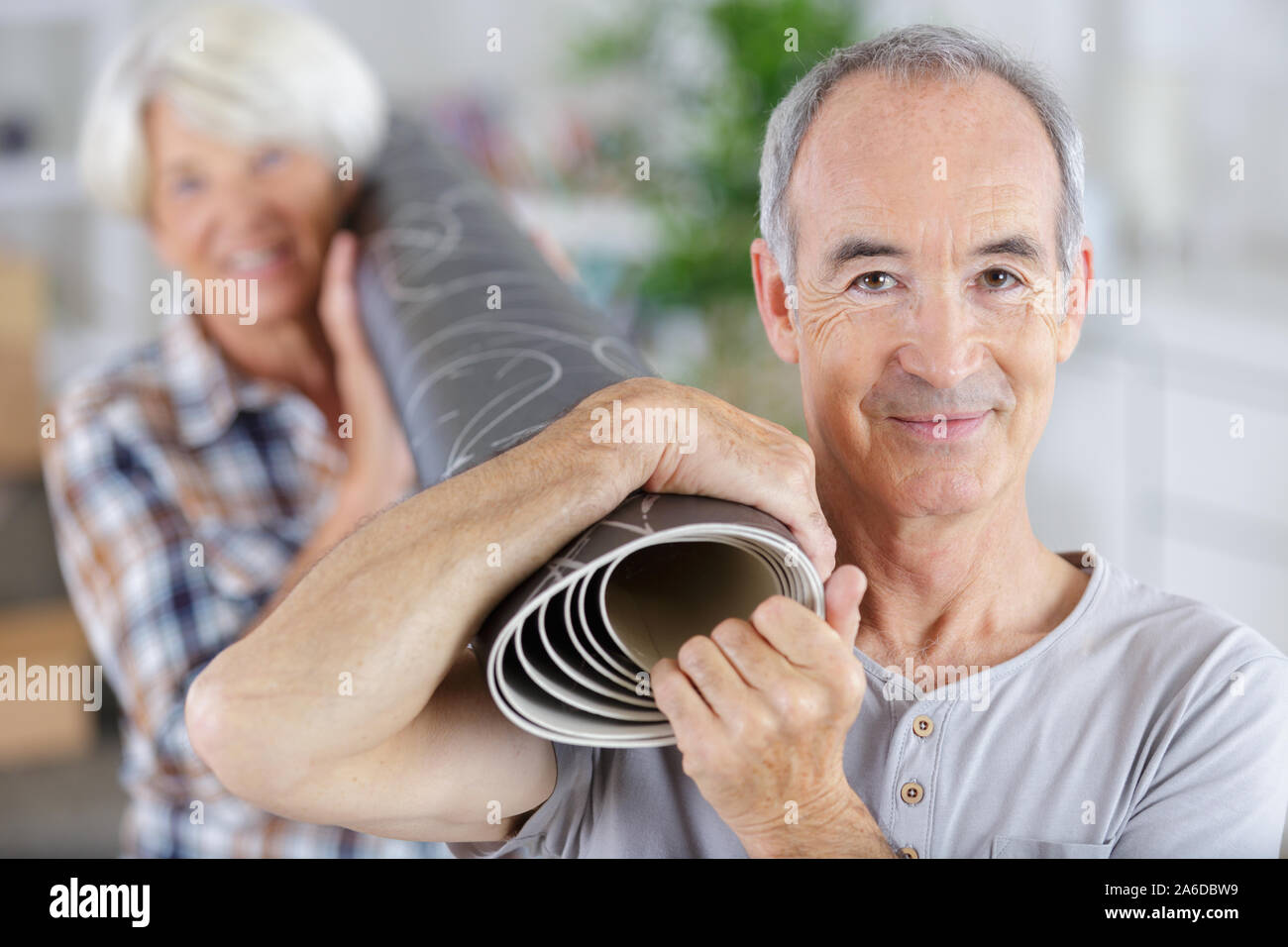 family lifting a heavy carpet Stock Photo - Alamy