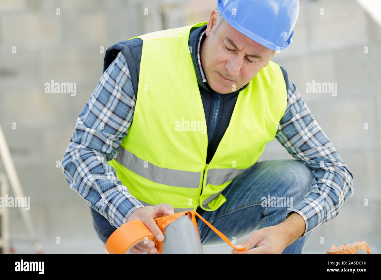 worker protecting wall with masking tape before painting Stock Photo ...