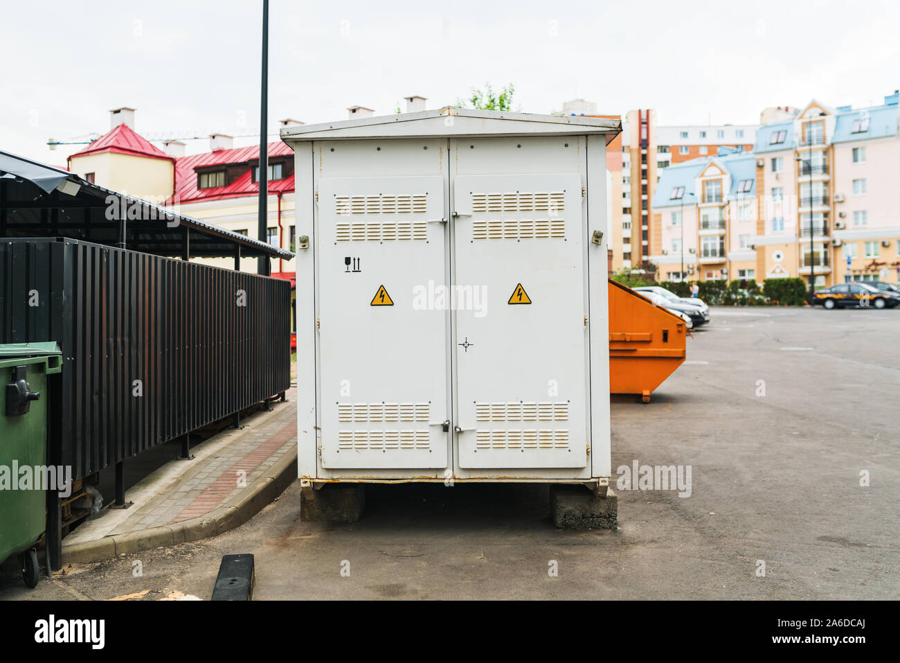 Grey electric Transformer room building with white doors and yellow ...