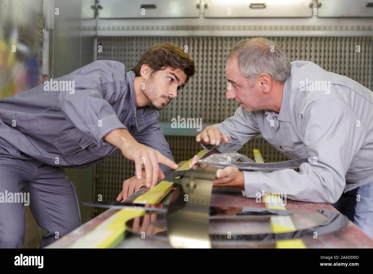 junior and senior production workers in discussion Stock Photo - Alamy