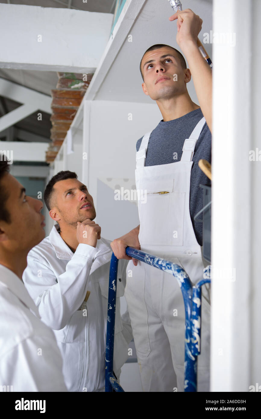 a painter touching the ceiling Stock Photo - Alamy