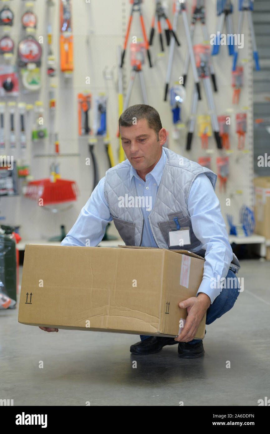 a delivery man giving cardbox Stock Photo - Alamy