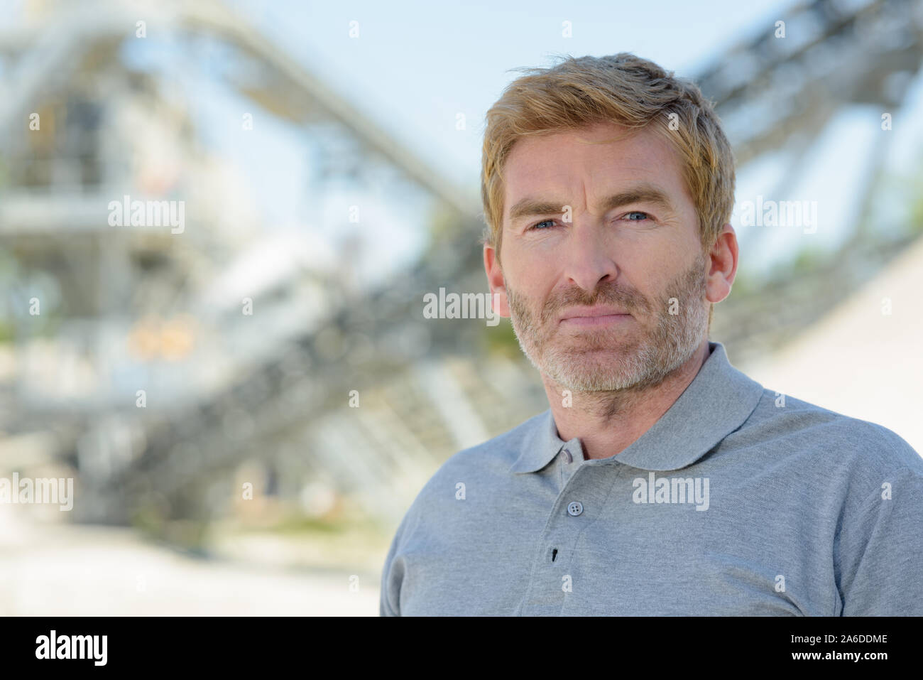 picture of a man in front of factory exterior Stock Photo - Alamy