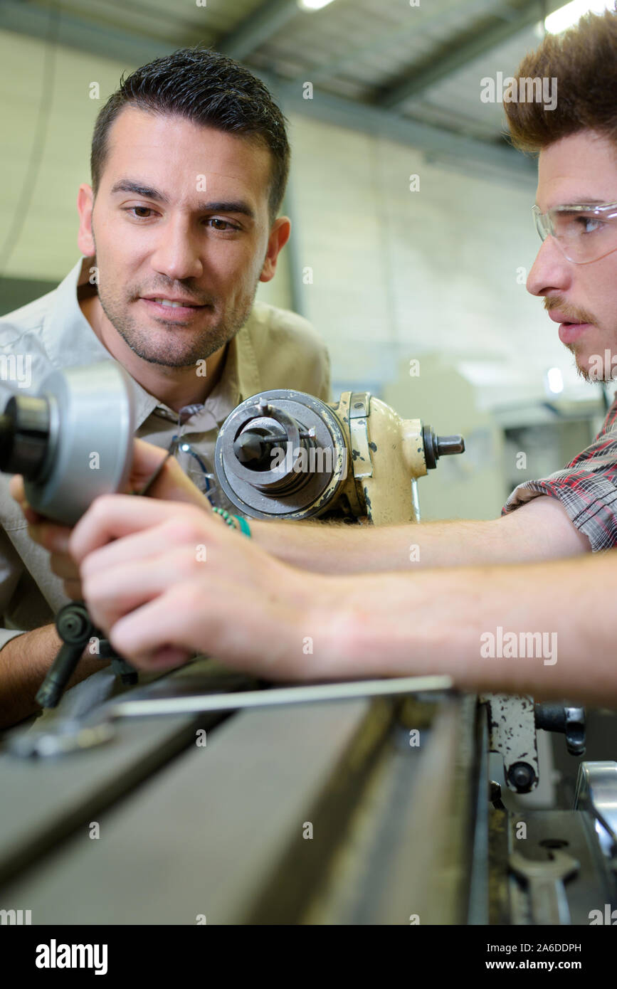 a portrait of apprentice working with engineer Stock Photo - Alamy