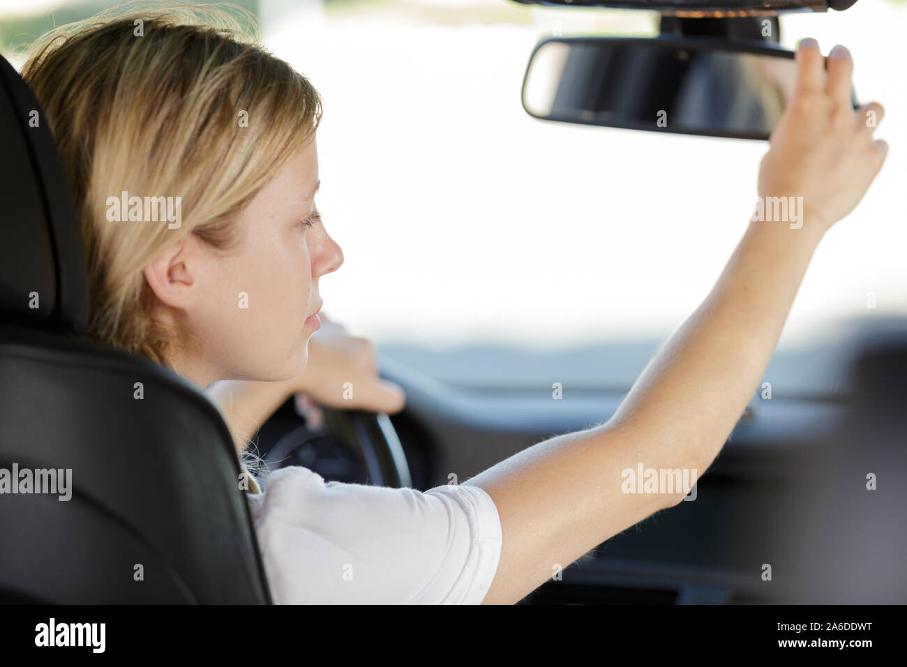 woman adjusting rear view mirror Stock Photo - Alamy