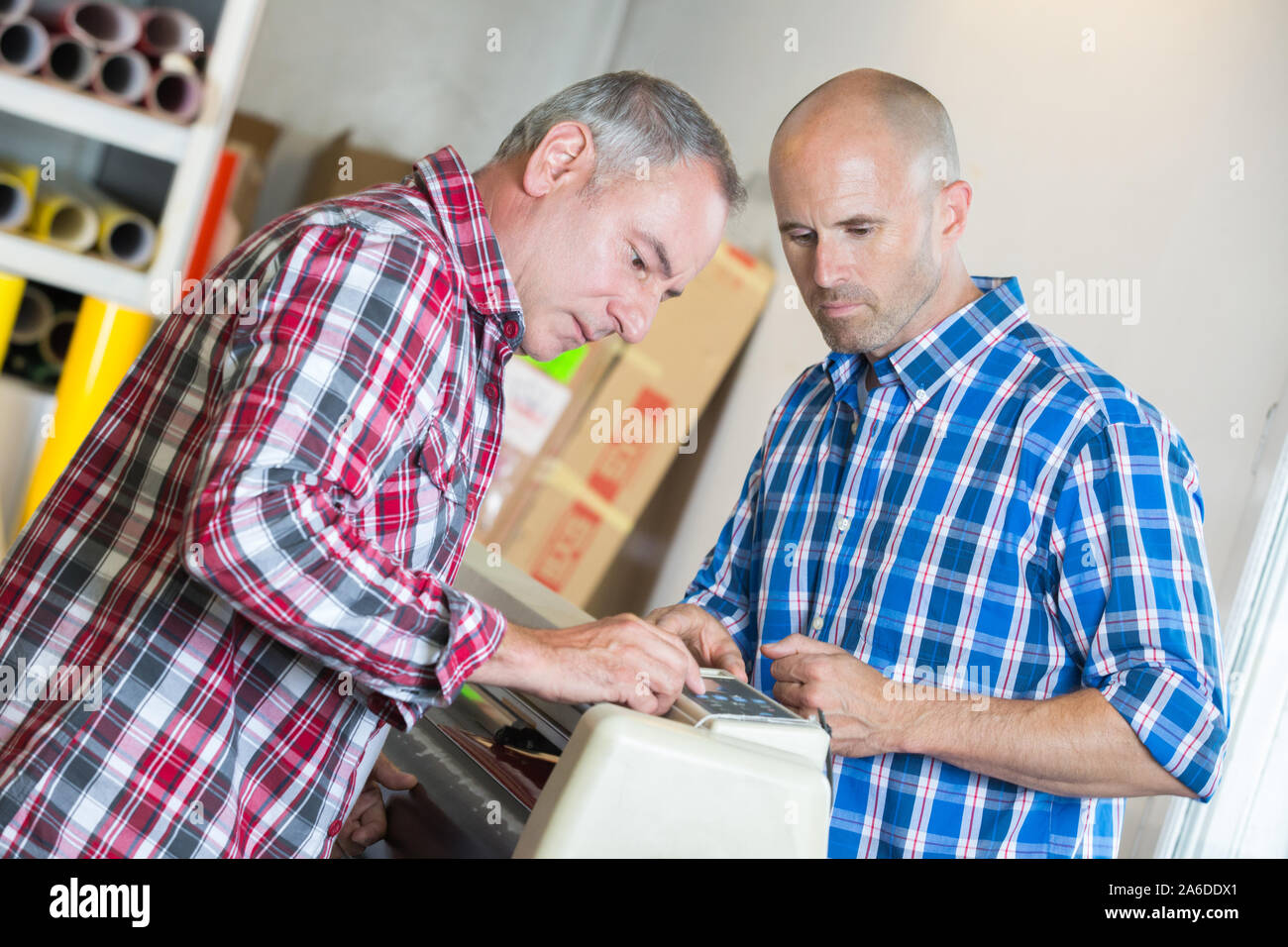 he is looking at printing machine Stock Photo - Alamy