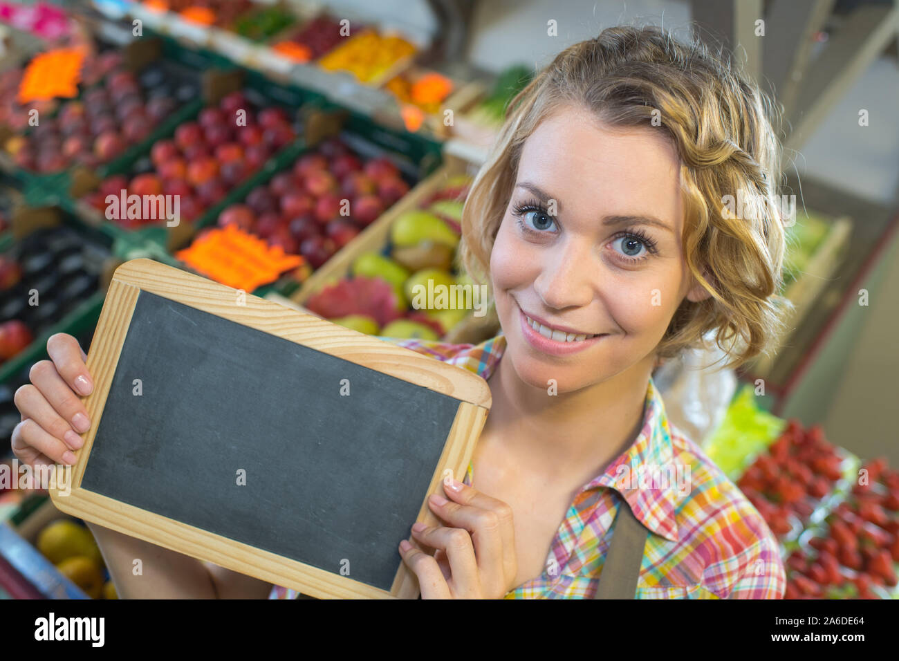 smiling staff holding organic sign board Stock Photo - Alamy