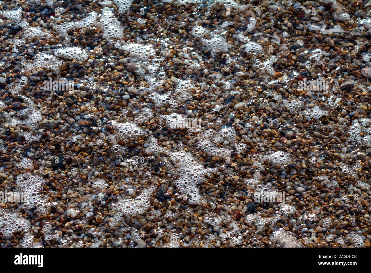 sea pebbles colored granite on the beach background stones. The shore ...