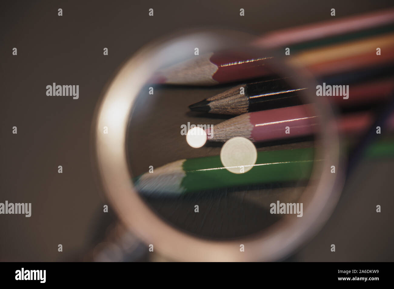 colorful drawing pencils; Color pencils under the magnifying glass ...