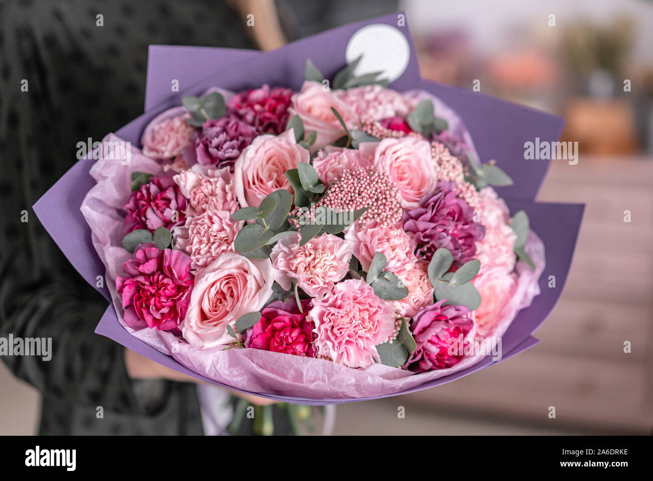 Beautiful bouquet of mixed flowers in womans hands. the work of the ...