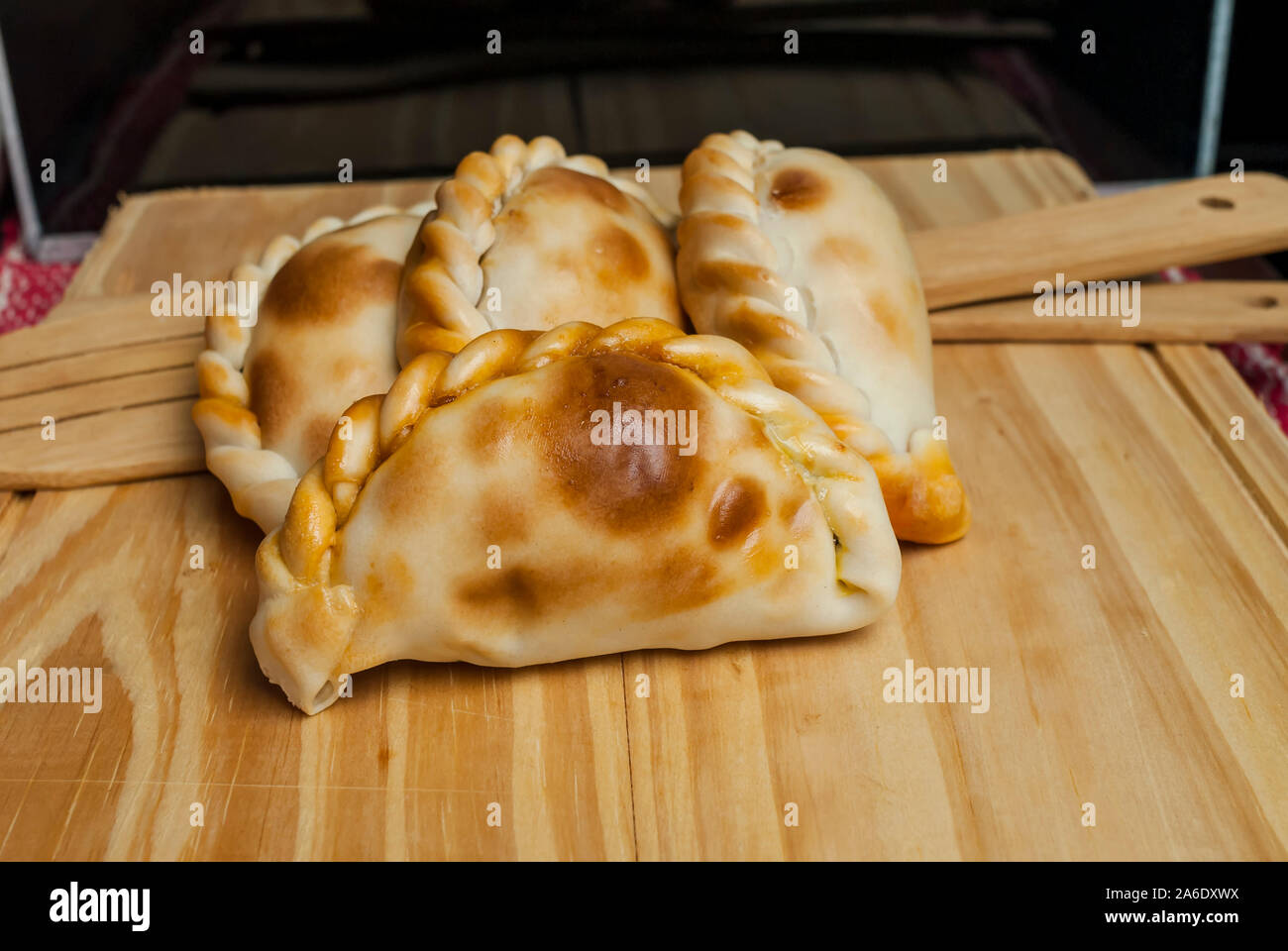 Wooden table with fresh homemade Empanadas (detailed close-up shot ...