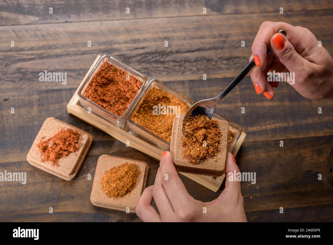 seasoning set on table with spoon and hand serving for cooking adding ...