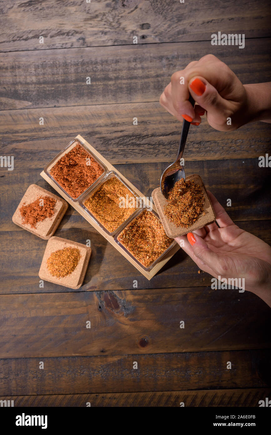 seasoning set on table with spoon and hand serving for cooking adding ...