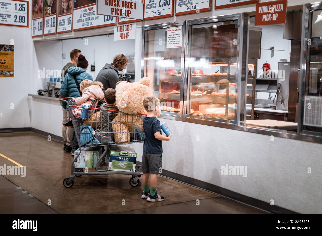 Tigard, Oregon - Oct 25, 2019 : A family are purchasing food with piled ...