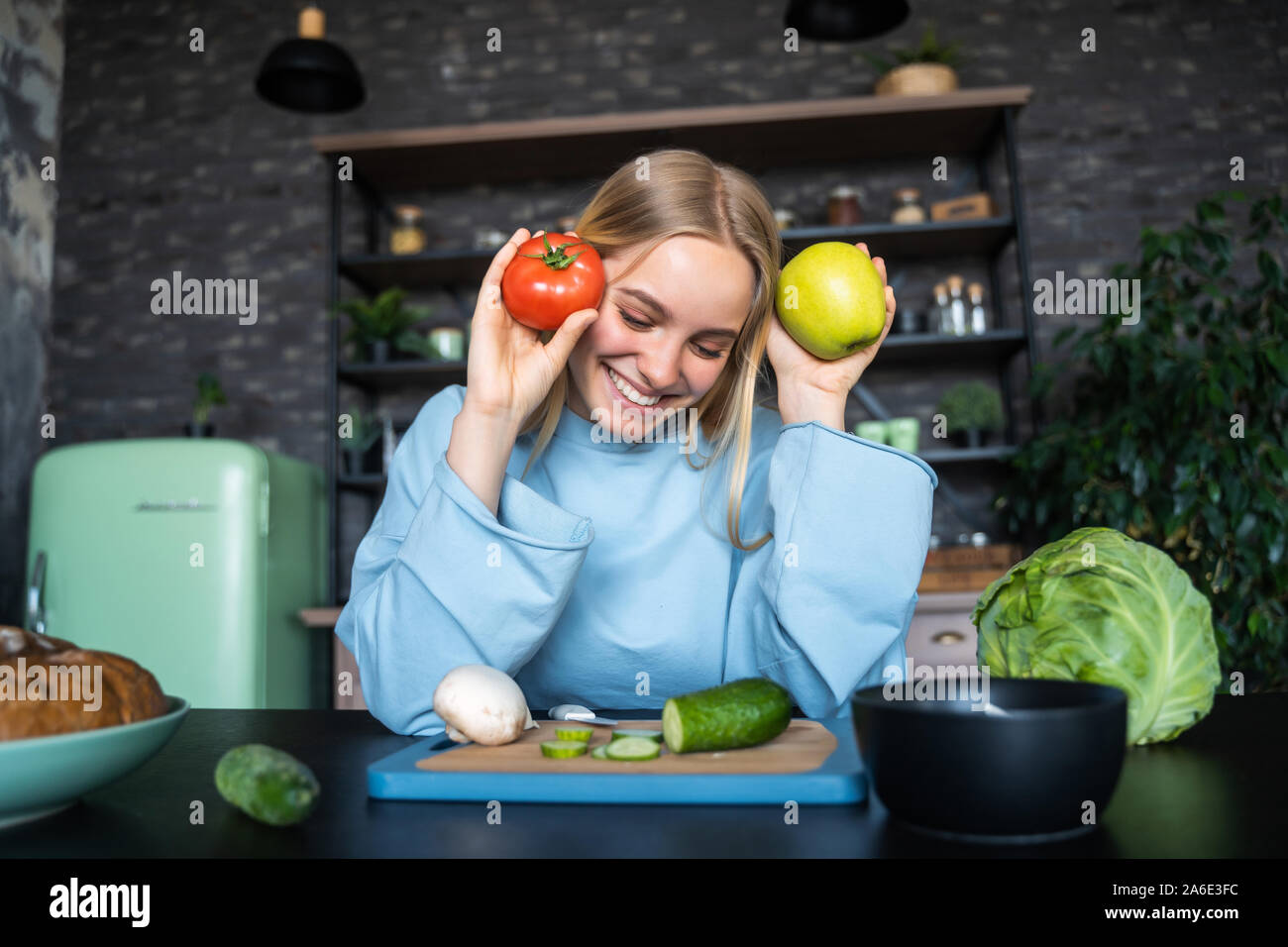 Beautiful young girl posing in the kitchen Stock Photo - Alamy