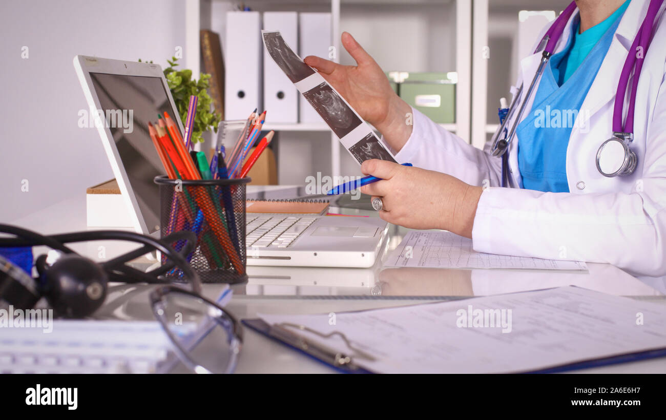 Female doctor at the desk in the office Stock Photo - Alamy