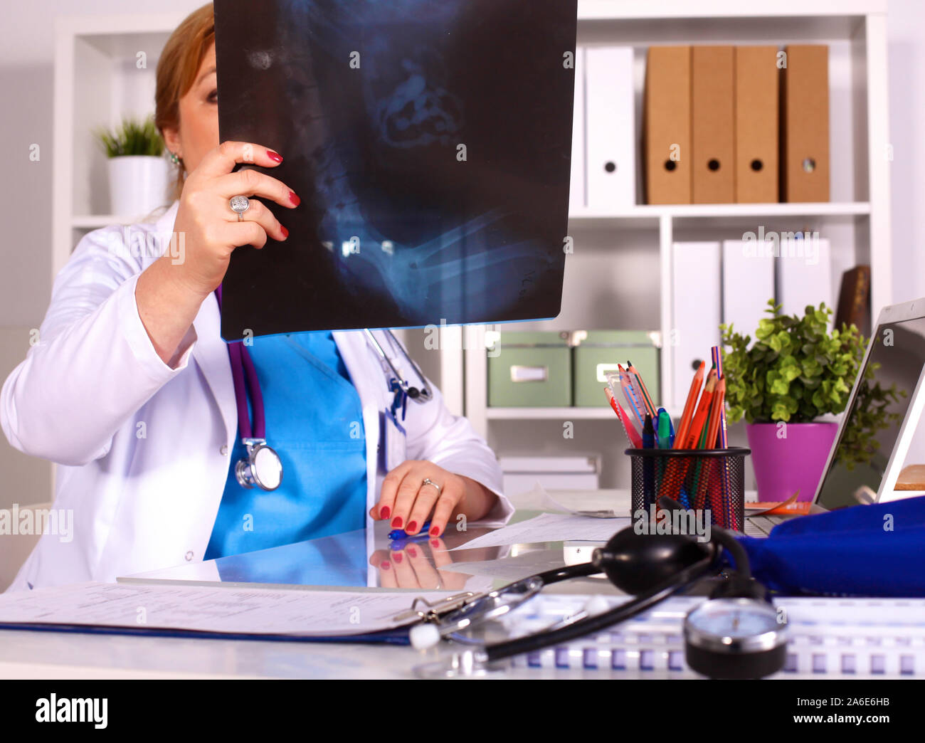 Female doctor at the desk in the office Stock Photo - Alamy
