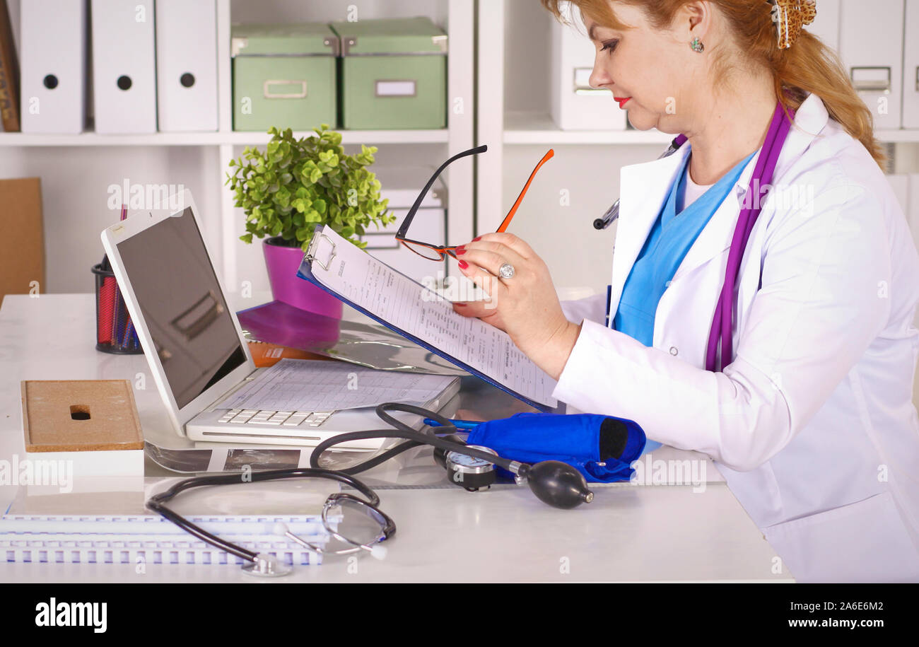 Female doctor at the desk in the office Stock Photo - Alamy
