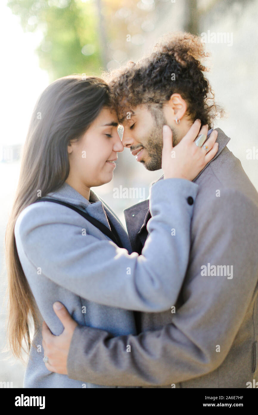 Girl hugging afro american handsome boy with curly hair Stock Photo - Alamy