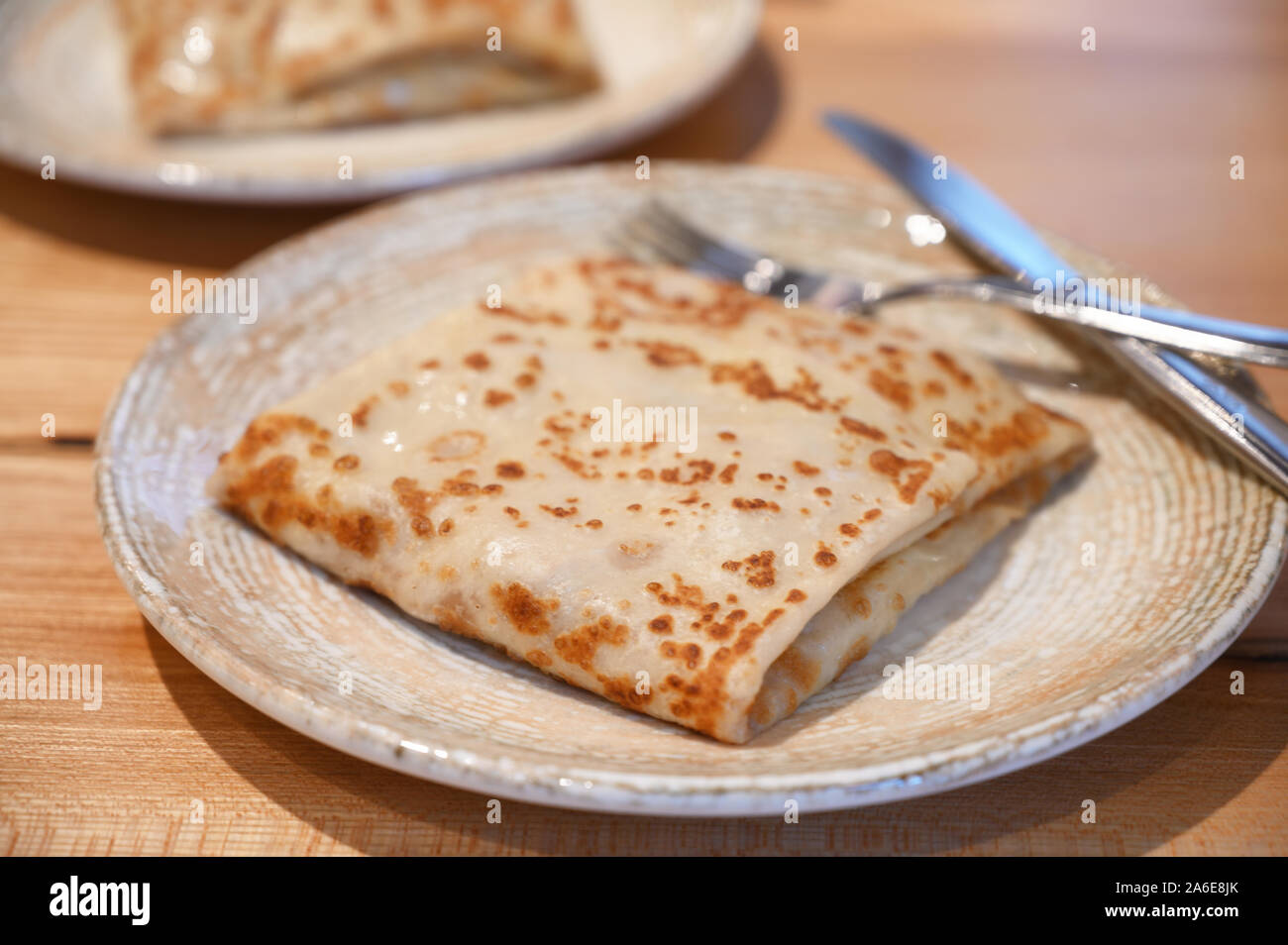 Traditional Russian dish blinis with cabbage filling on a plate Stock ...