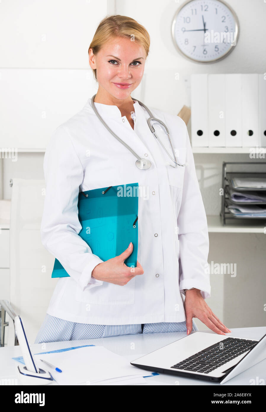 portrait of young smiling swiss doctor in uniform with clipboard in ...