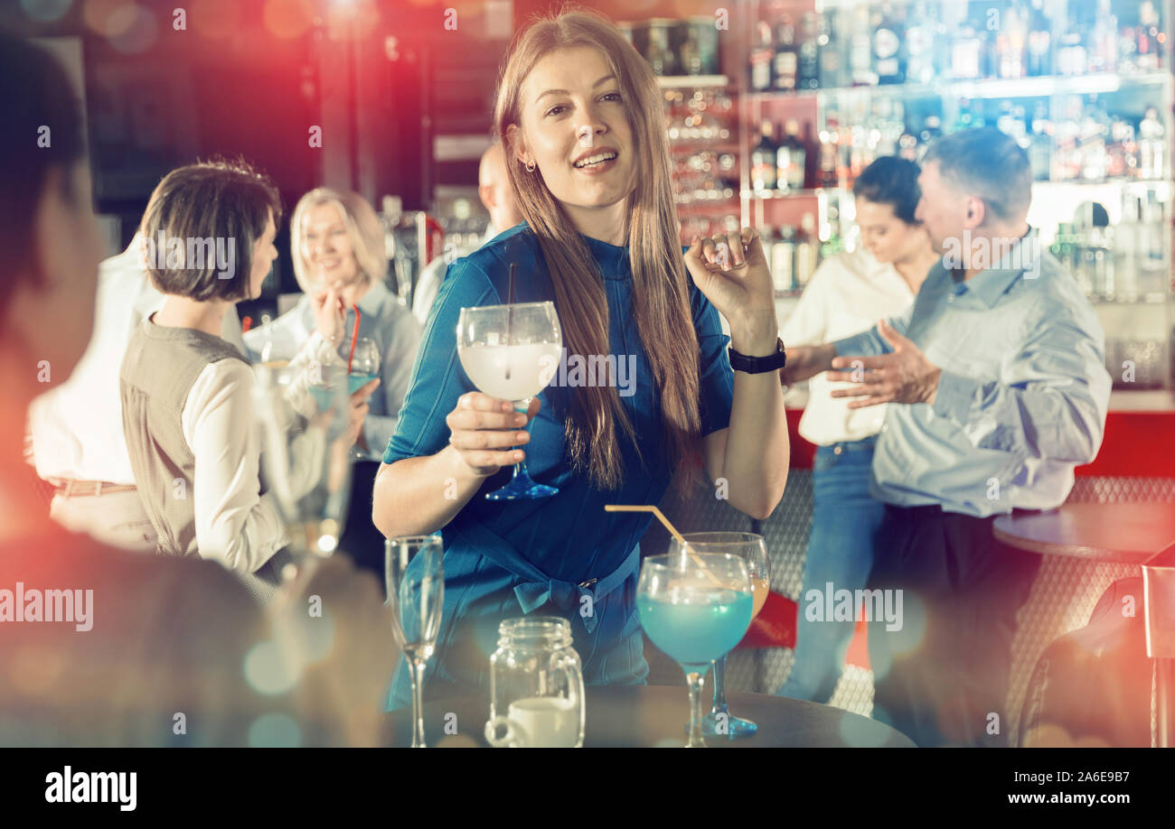Cheerful attractive girl with cocktails having fun with workmates on ...