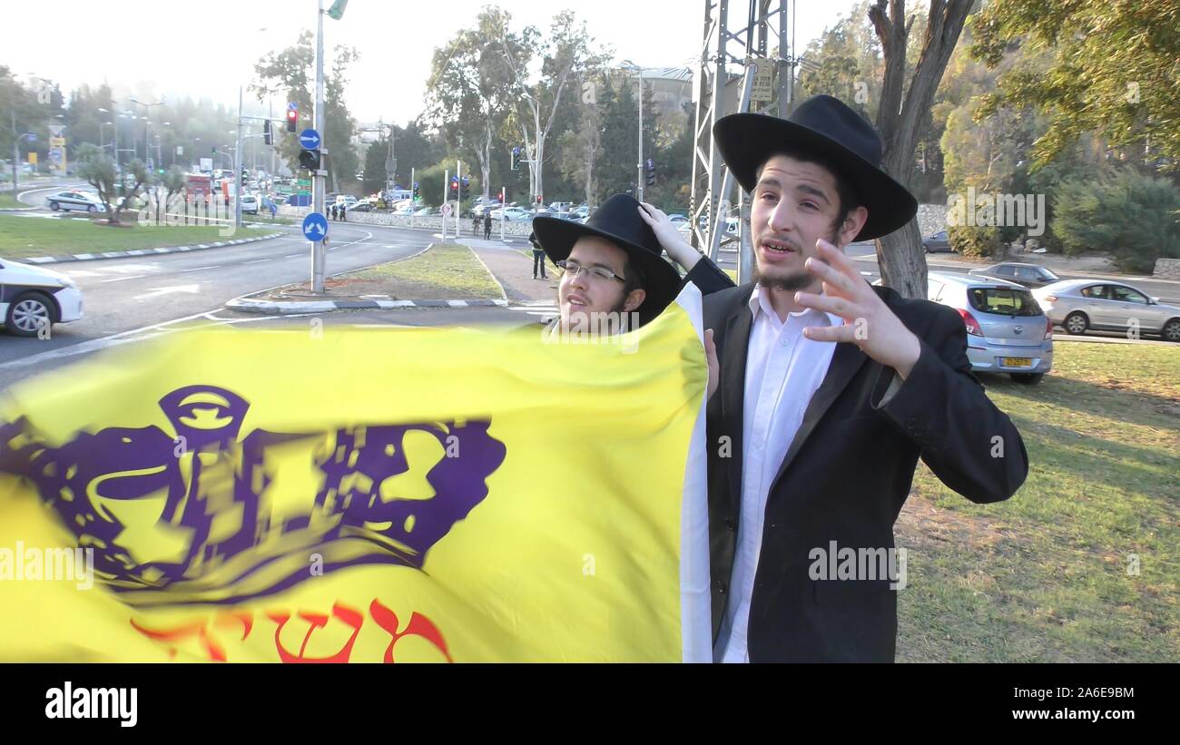 Young Hassidic Jews with flag try to attract people to get ready the ...