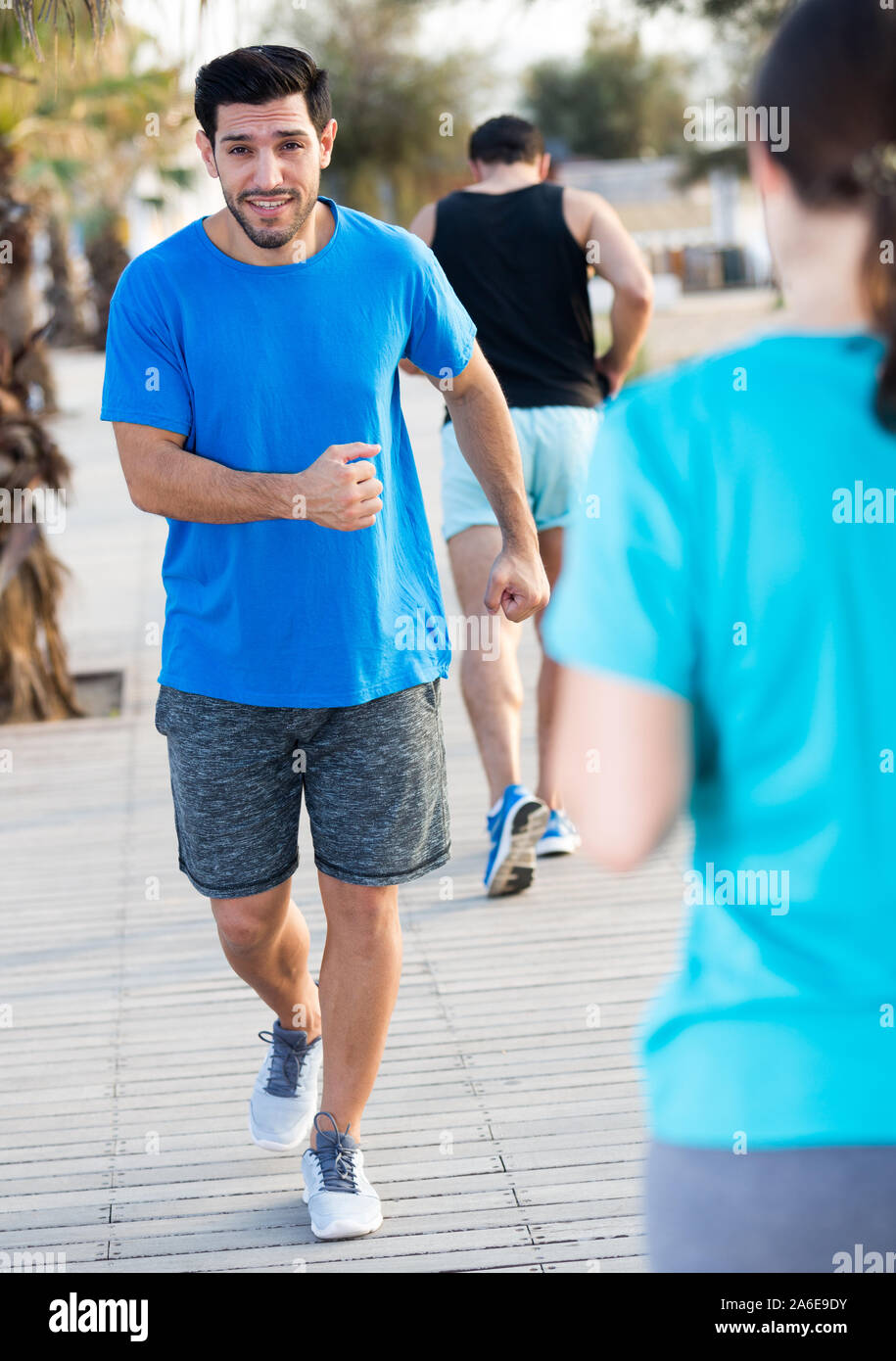 Two friends are doing race in time training in the park near sea Stock ...